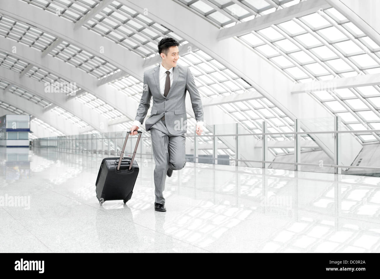 Young businessman in a hurry at the airport Stock Photo - Alamy