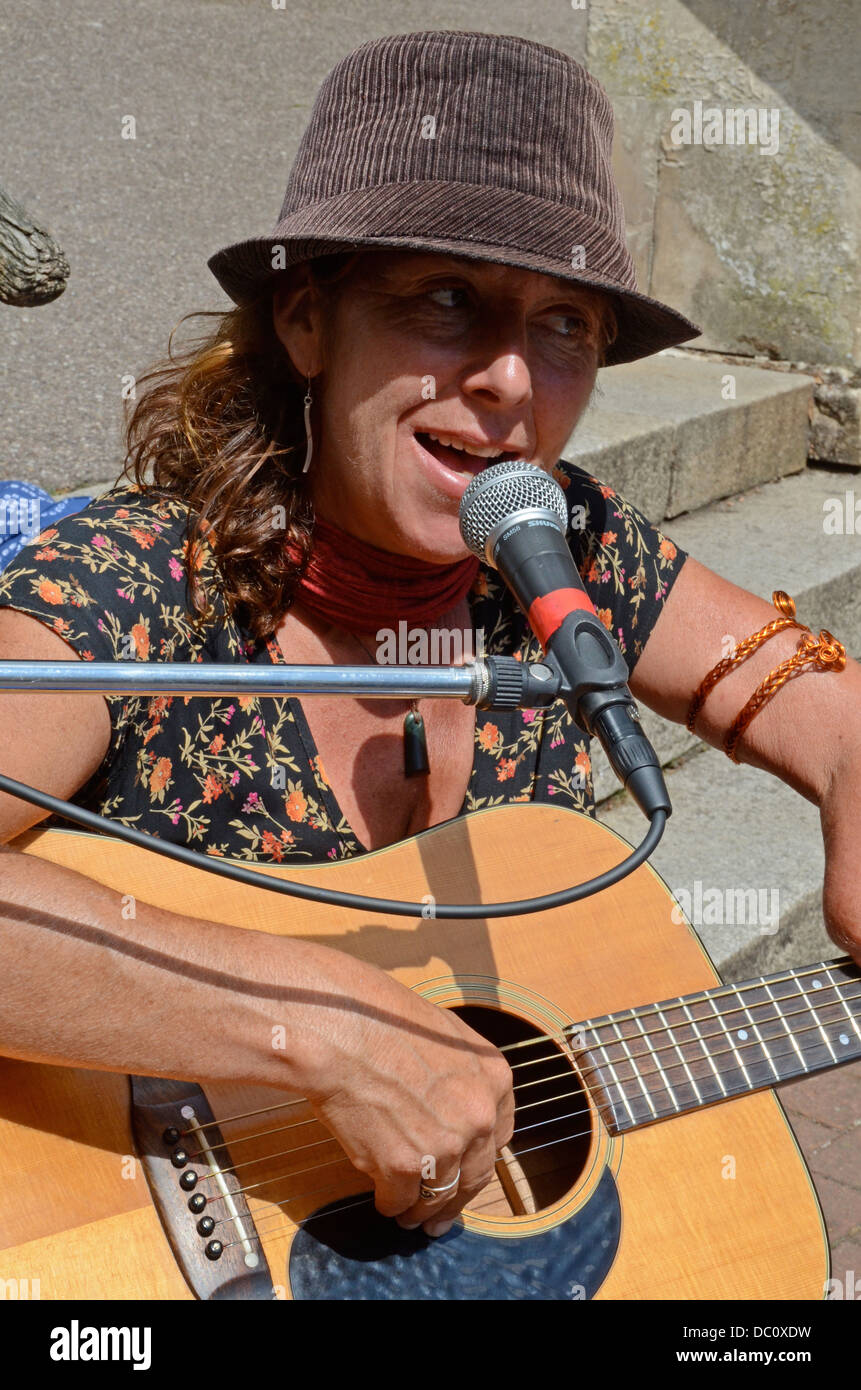 Woman playing guitar singing busking hi-res stock photography and ...