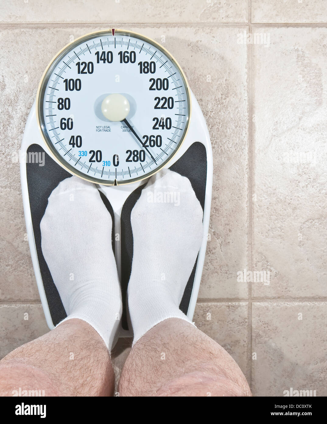 Person in white socks and bare legs standing on scale reading over 280 ...