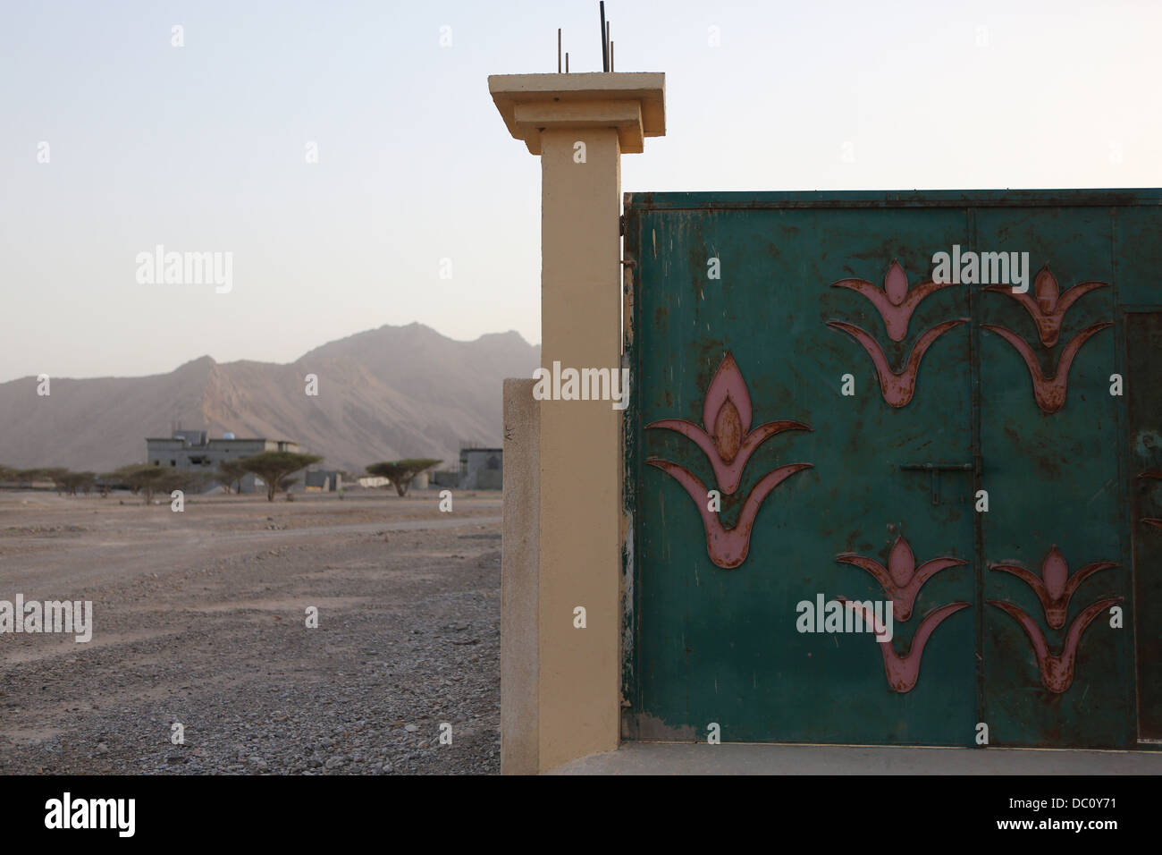 The outside gate of an abandoned plot of land in the town of Dibba ...