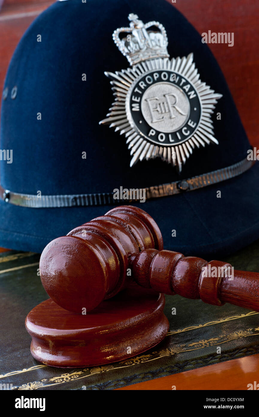 Metropolitan Police helmet with judges gavel in London law courts ...