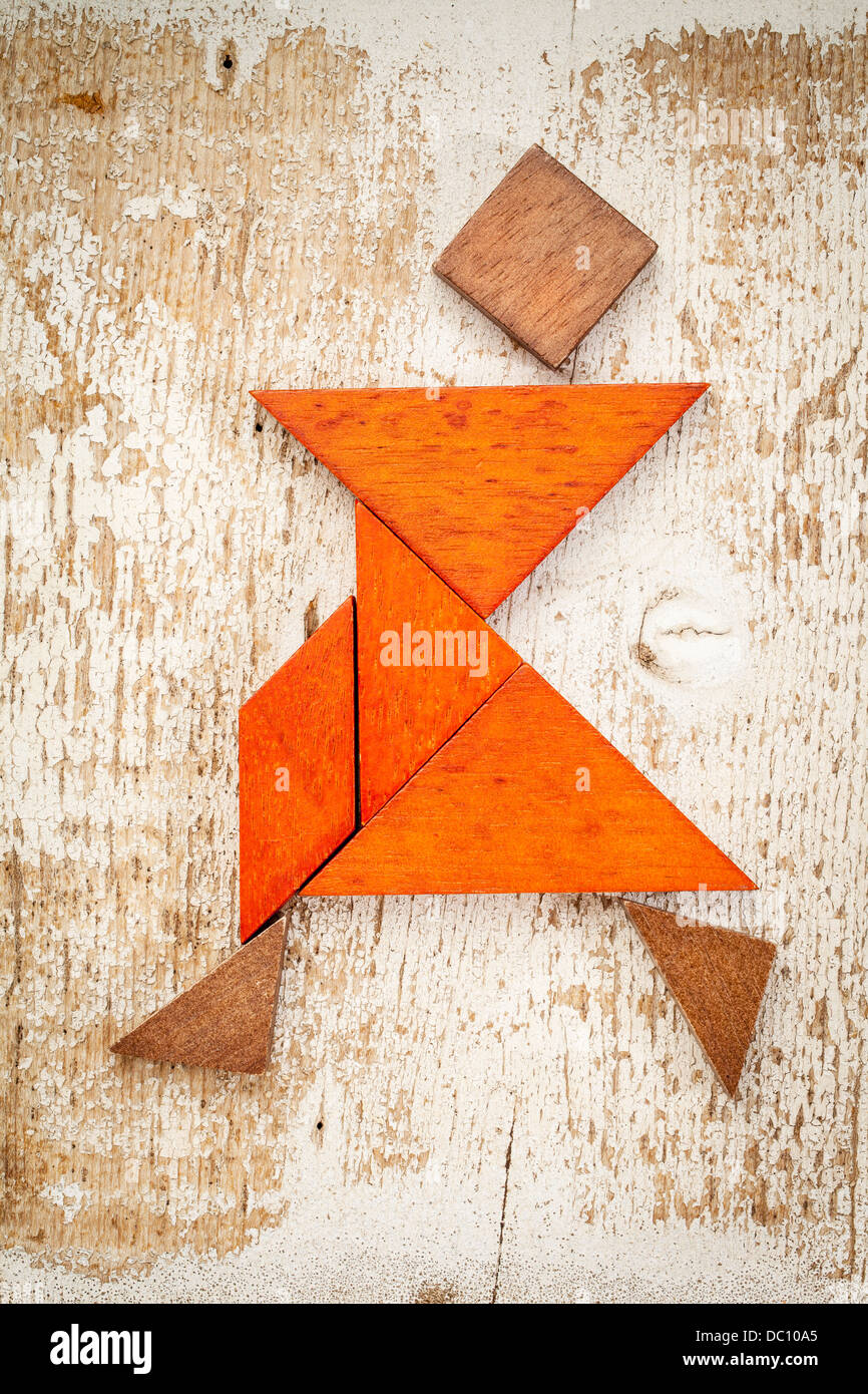 abstract figure of a female dancer built from seven tangram wooden ...