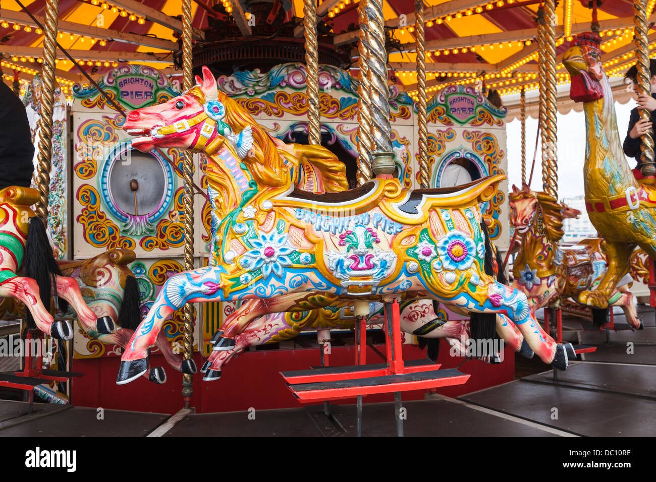 Brightly coloured horse on merry-go-round in the funfair on Brighton ...