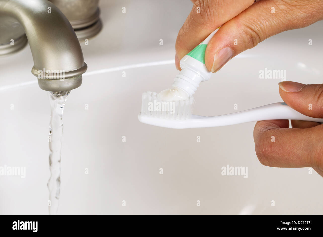 Closeup of horizontal Photo of female hands putting tooth paste on ...