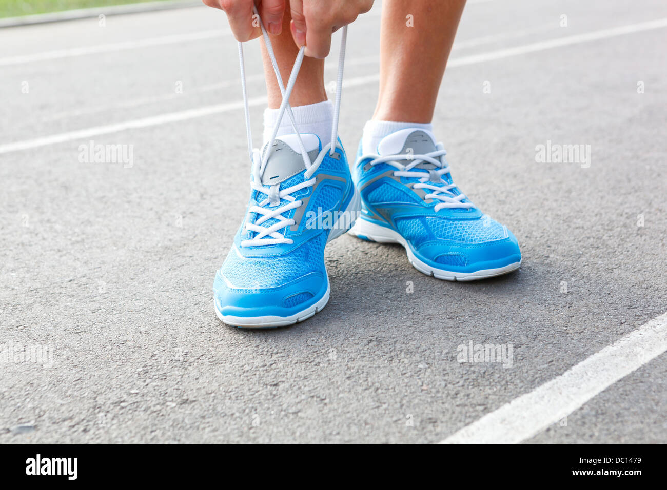 Woman tying her shoe hi-res stock photography and images - Alamy