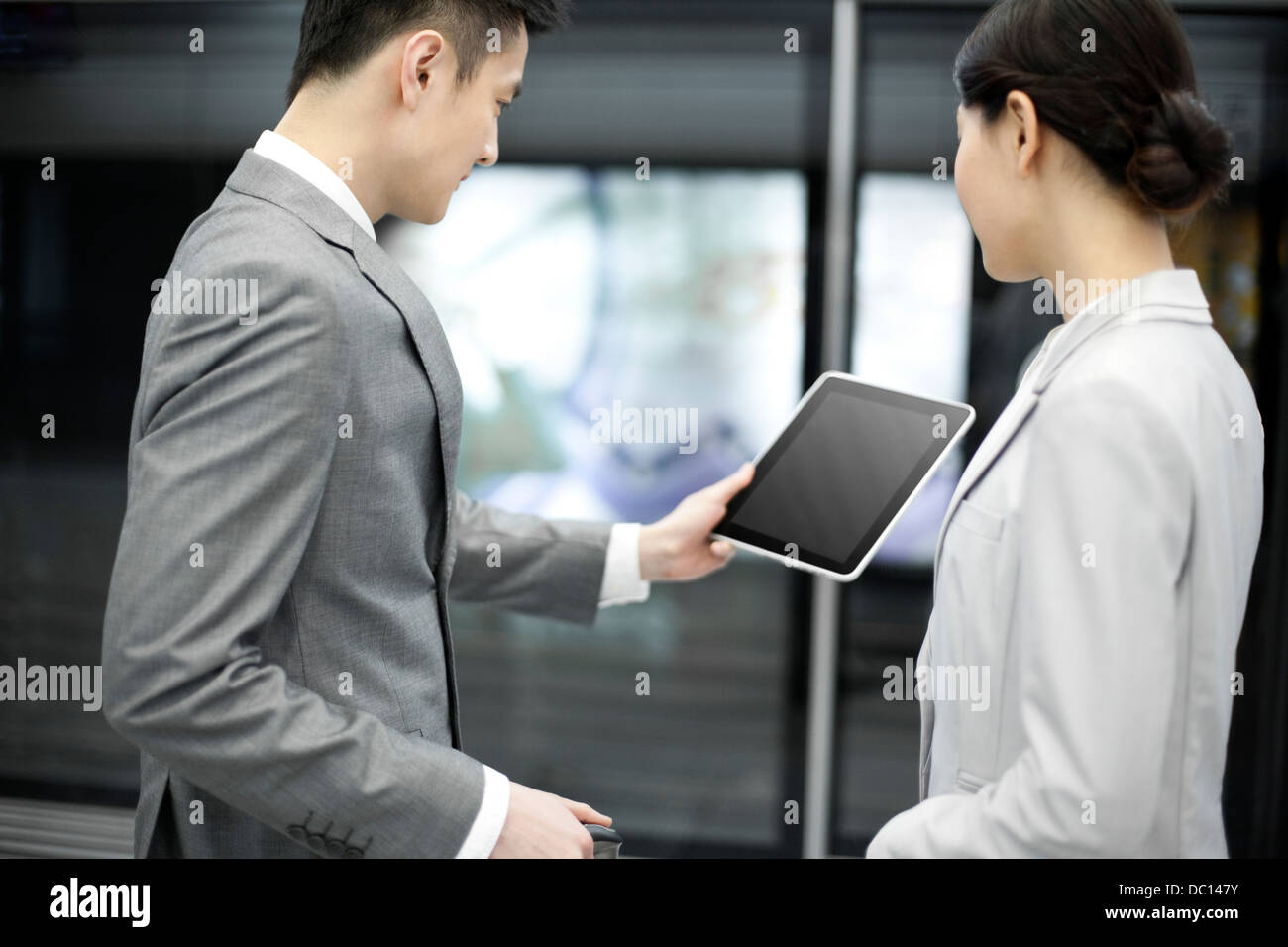 Young business partners with digital tablet on subway platform Stock ...