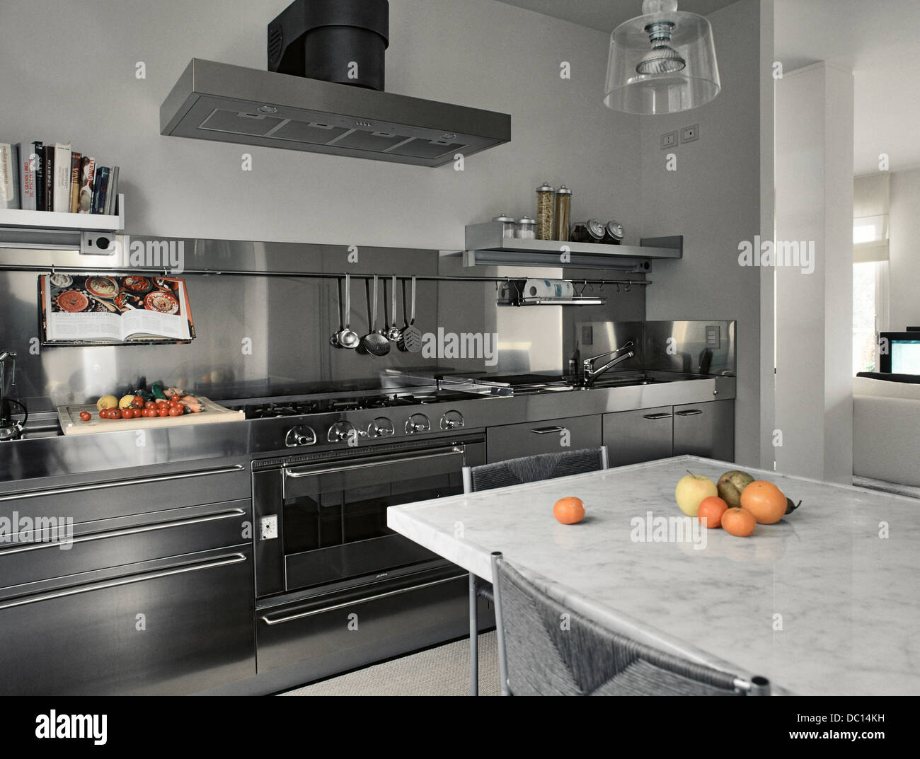 modern steel kitchen with marble dining table Stock Photo - Alamy