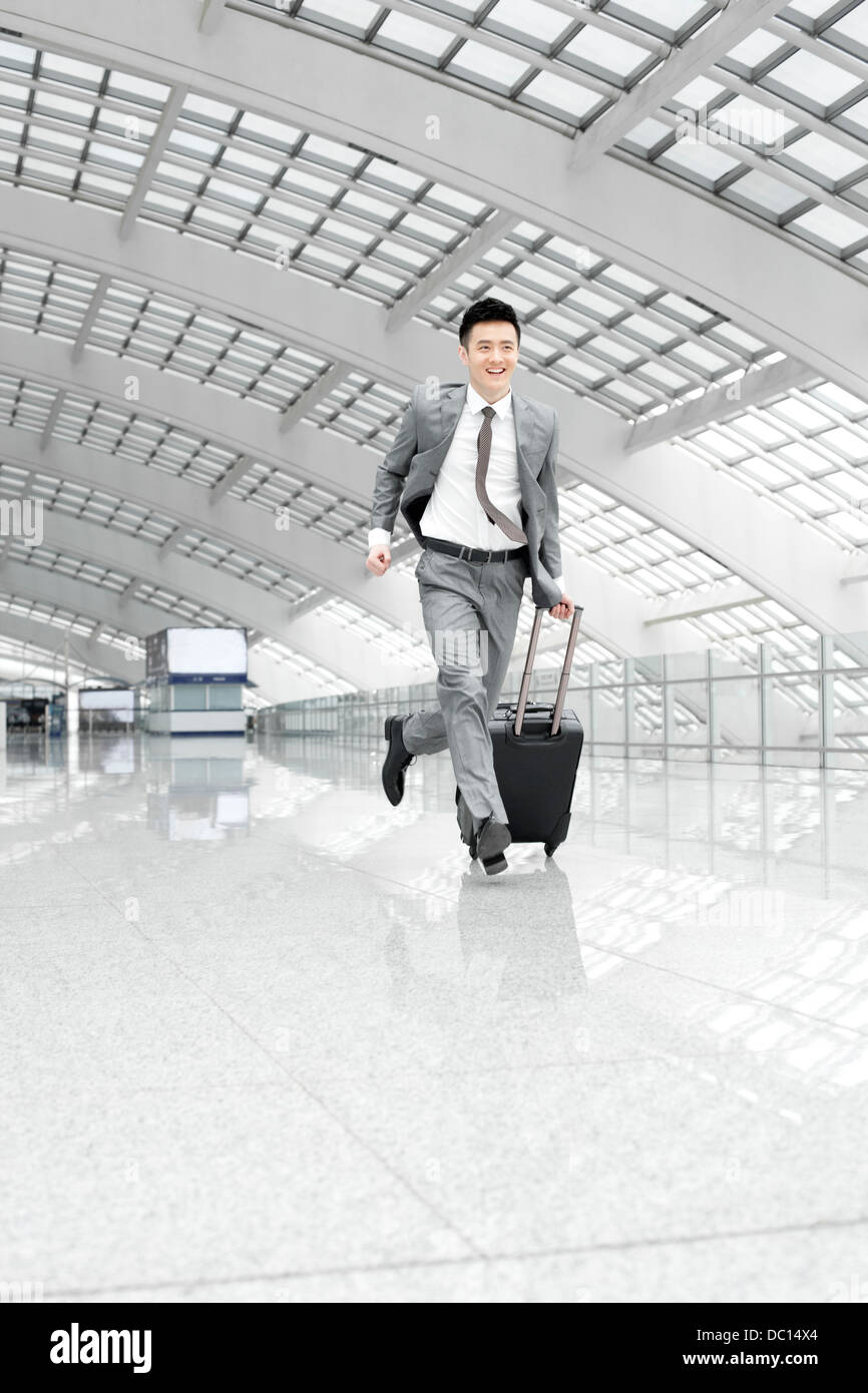 Young businessman in a hurry at the airport Stock Photo - Alamy