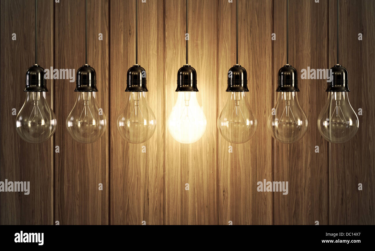 Seven light bulbs with glowing one on wooden background Stock Photo - Alamy