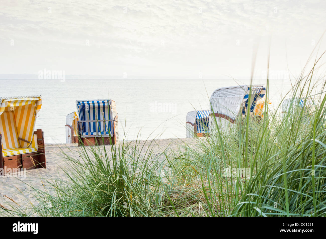 Traditional german Beach chairs at the baltic sea beach during sunrise ...