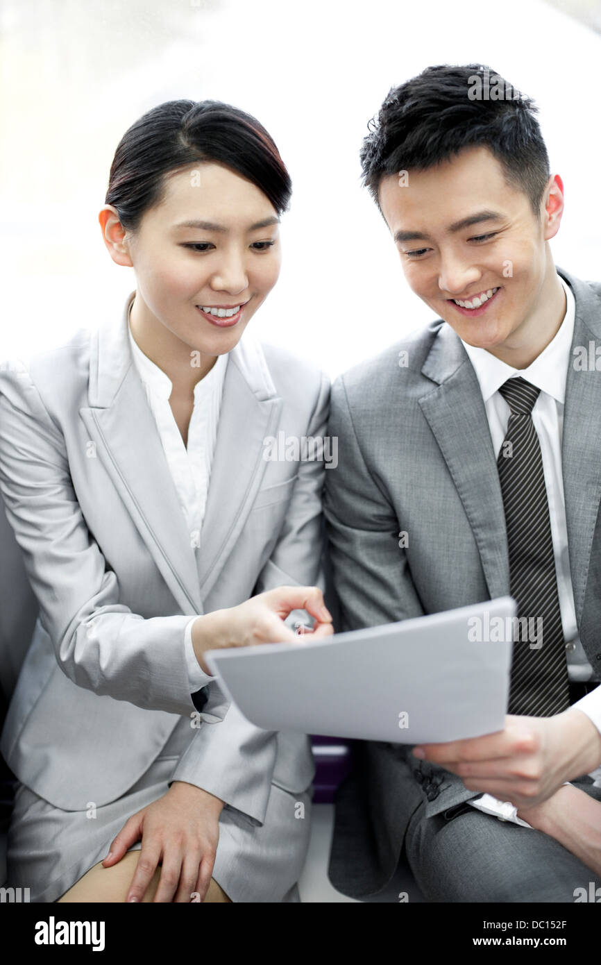 Business partners reading files in hi-res stock photography and images ...