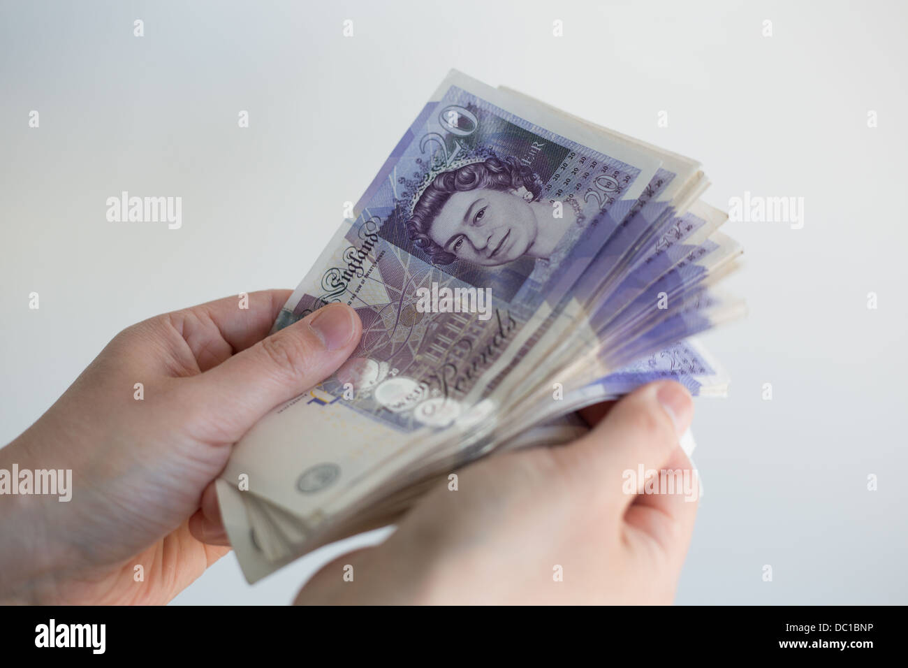Hand holding bundle of British Bank of England 20pound GBP notes Stock ...
