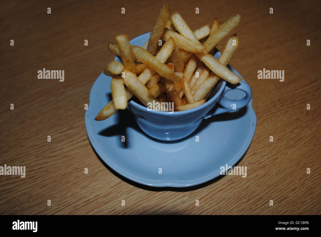French fries in a tea cup Stock Photo - Alamy