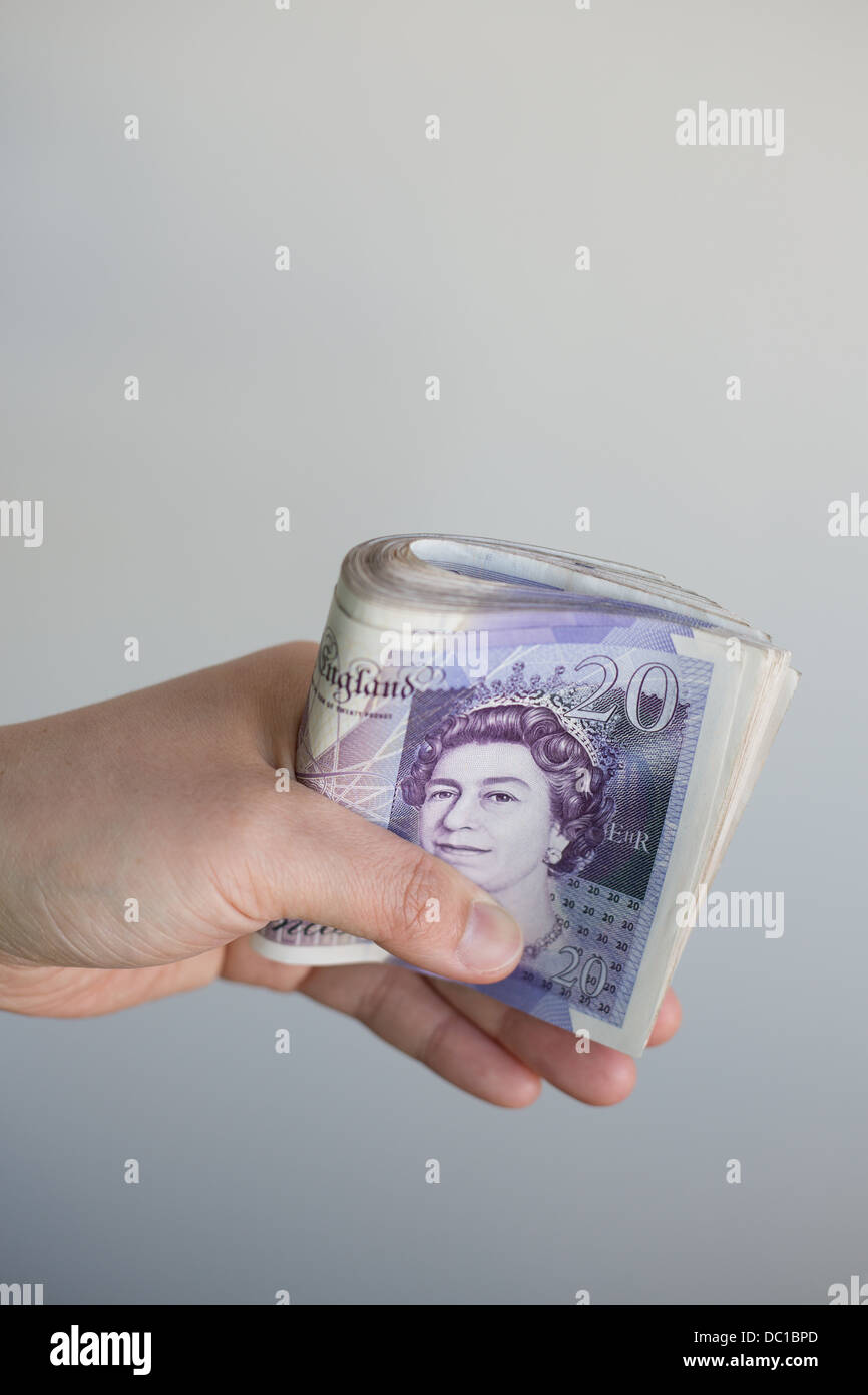 Hand holding british banknotes hi-res stock photography and images - Alamy