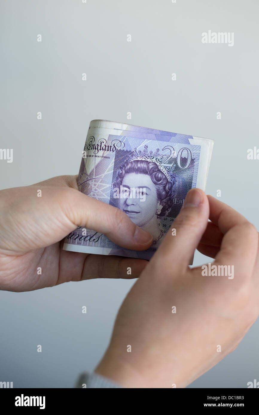 Hand holding british banknotes hi-res stock photography and images - Alamy
