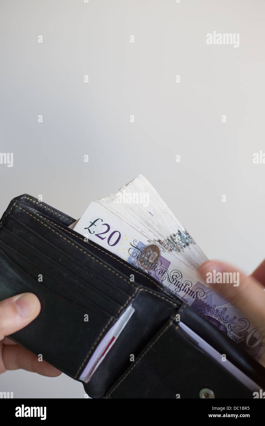 Hand holding british banknotes hi-res stock photography and images - Alamy