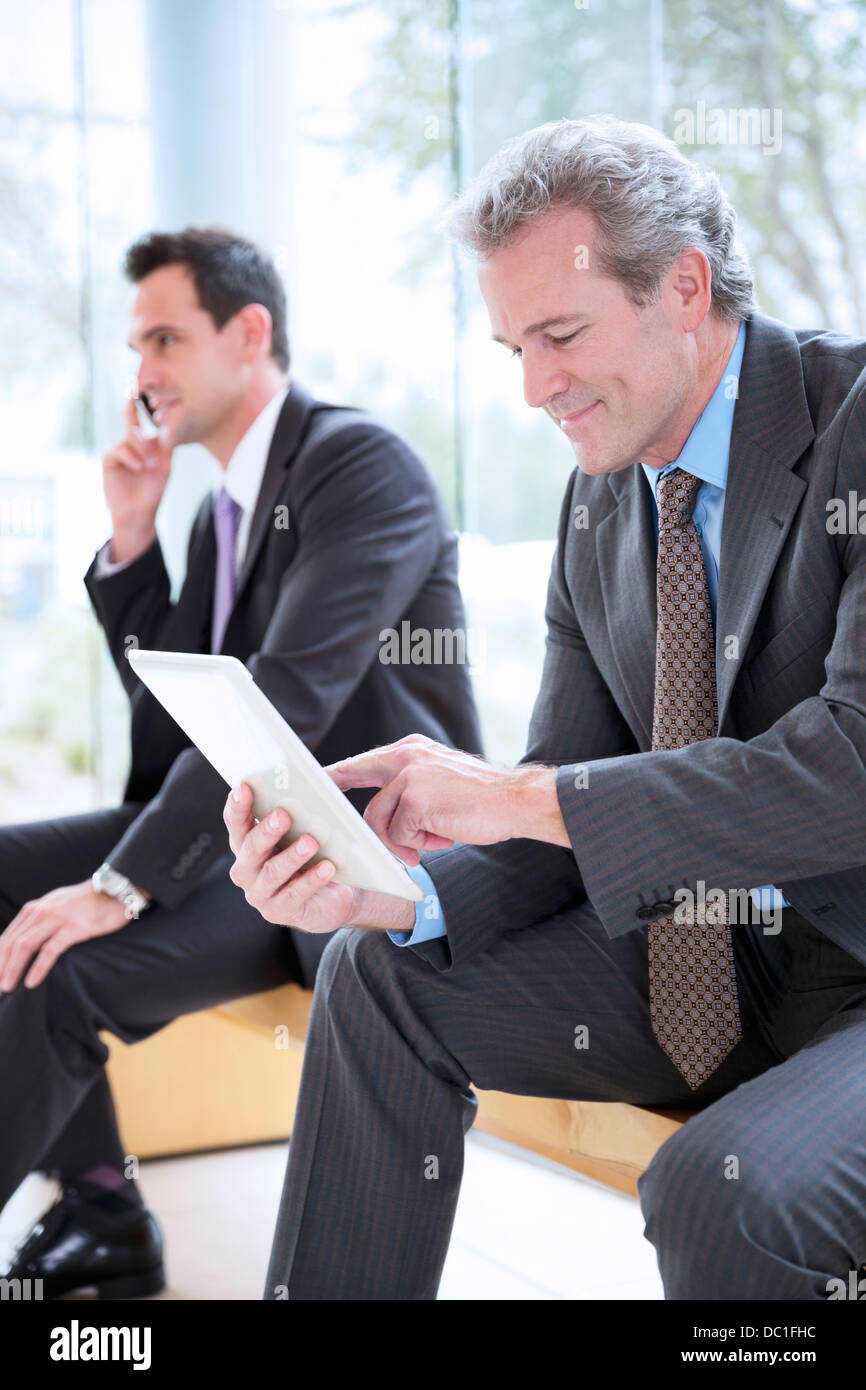 Young businessman using tablet sitting hi-res stock photography and ...
