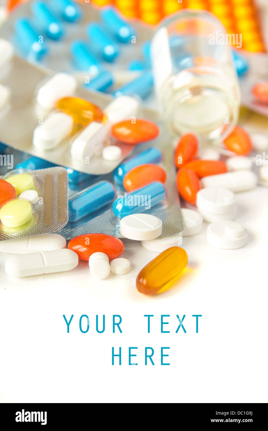 Assorted colorful pills and capsules on white background close up ...