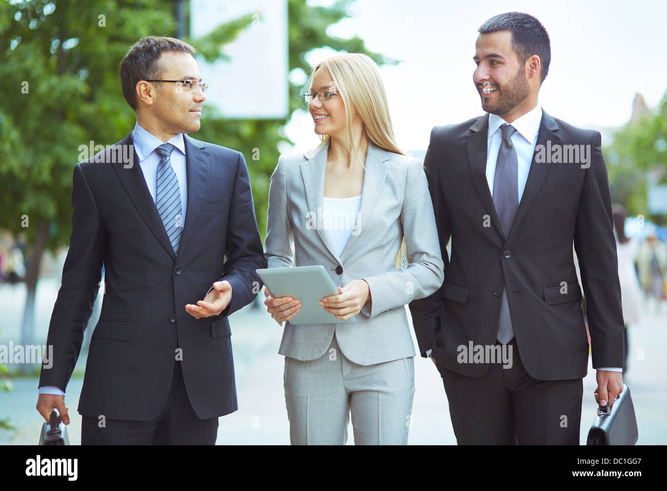 Image of friendly business team communicating outside Stock Photo - Alamy