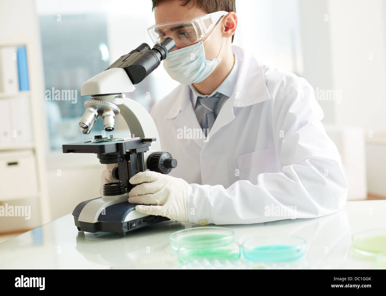 Serious researcher studying chemical element in laboratory Stock Photo ...