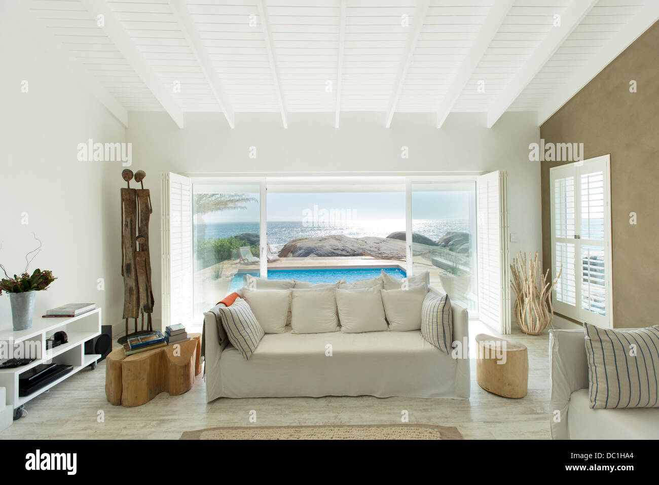 Living room overlooking swimming pool Stock Photo - Alamy