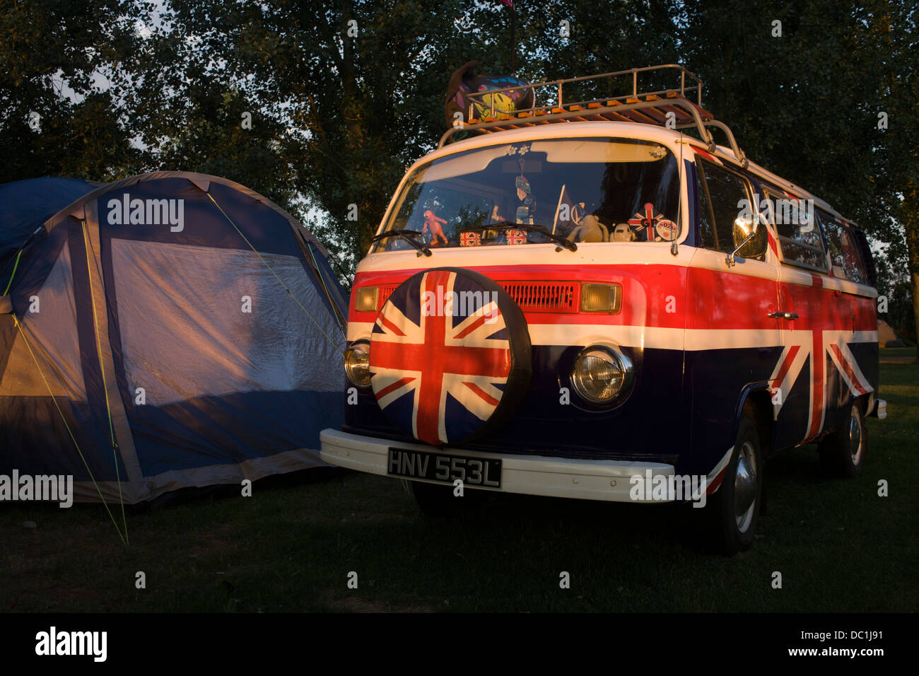 A VW camper van adorned with British Union Jacks colours, on a campsite ...