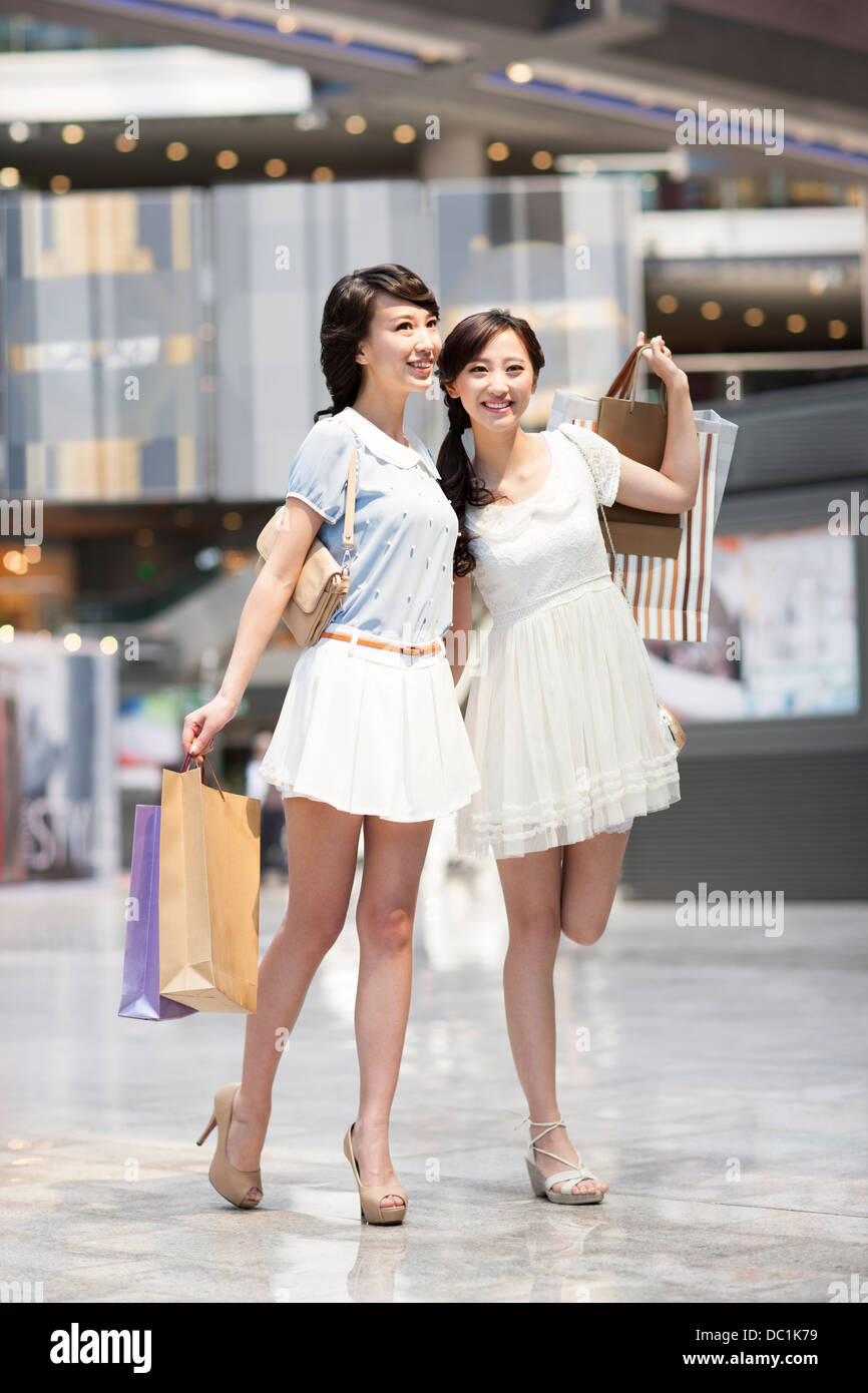 Stylish female friends shopping Stock Photo - Alamy