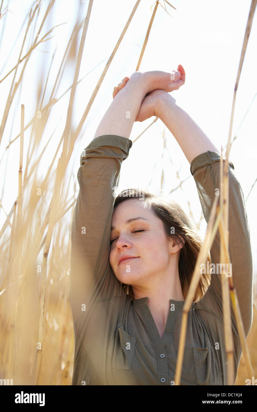 Portrait of young woman amongst reeds Stock Photo - Alamy