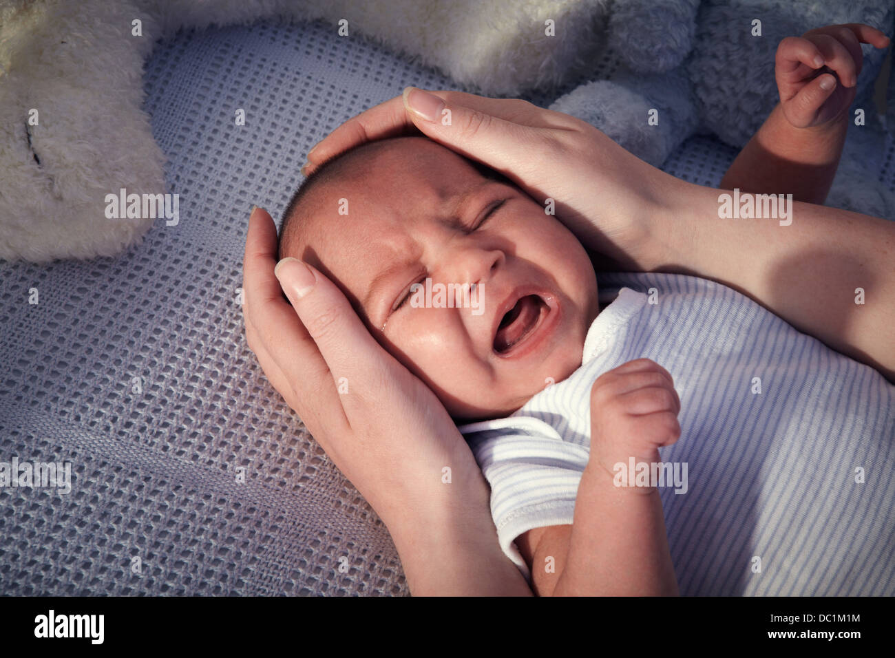 Baby crying on mother hi-res stock photography and images - Alamy