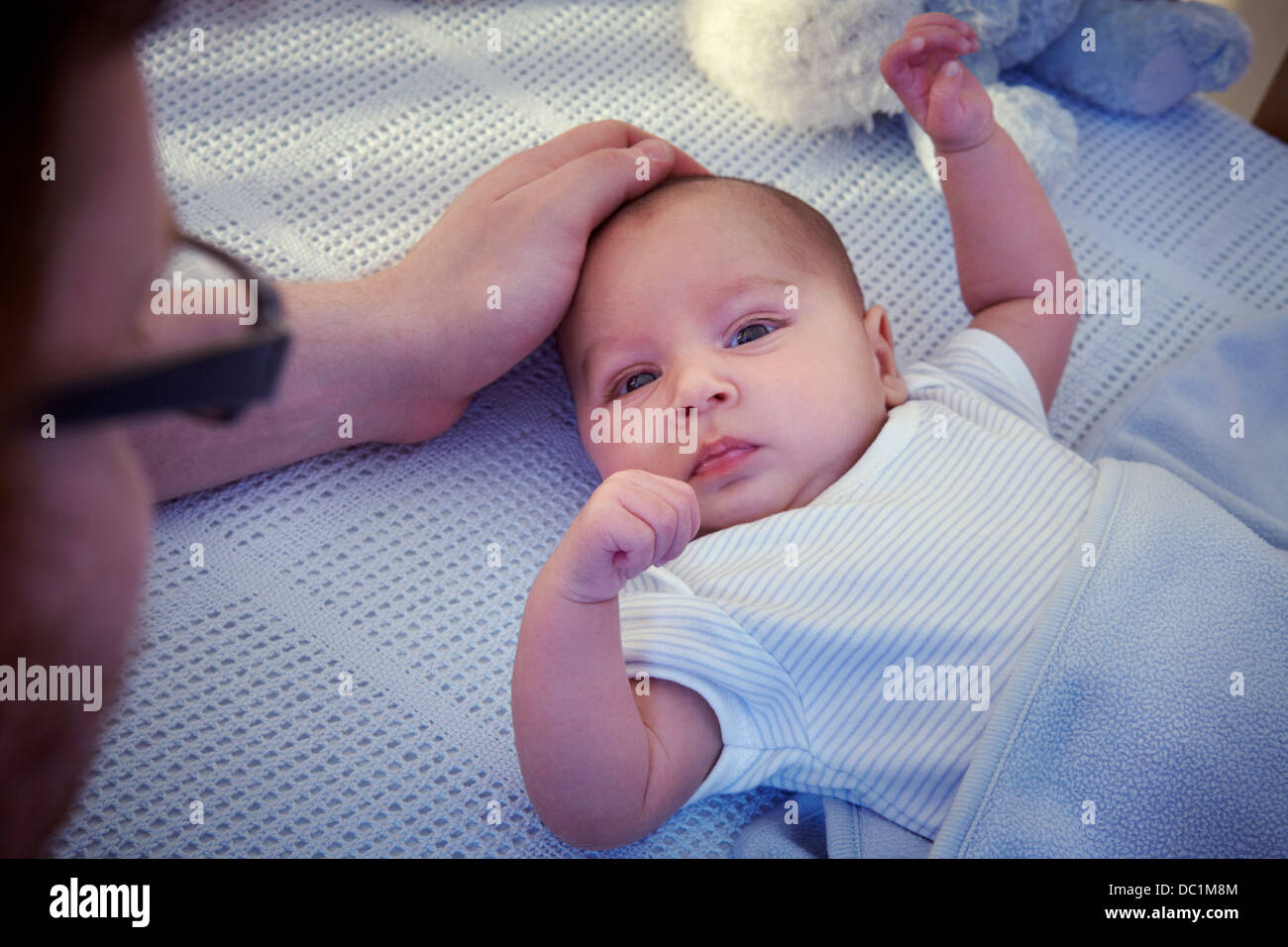 Father consoling baby in crib Stock Photo - Alamy