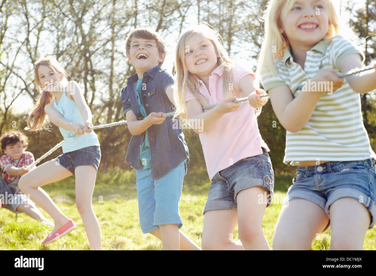Group of children playing tug o war Stock Photo - Alamy