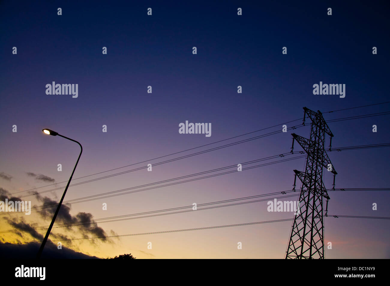 Streetlight and electricity pylon Stock Photo - Alamy