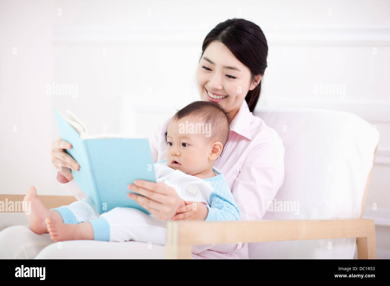 mother reading a book to baby Stock Photo - Alamy