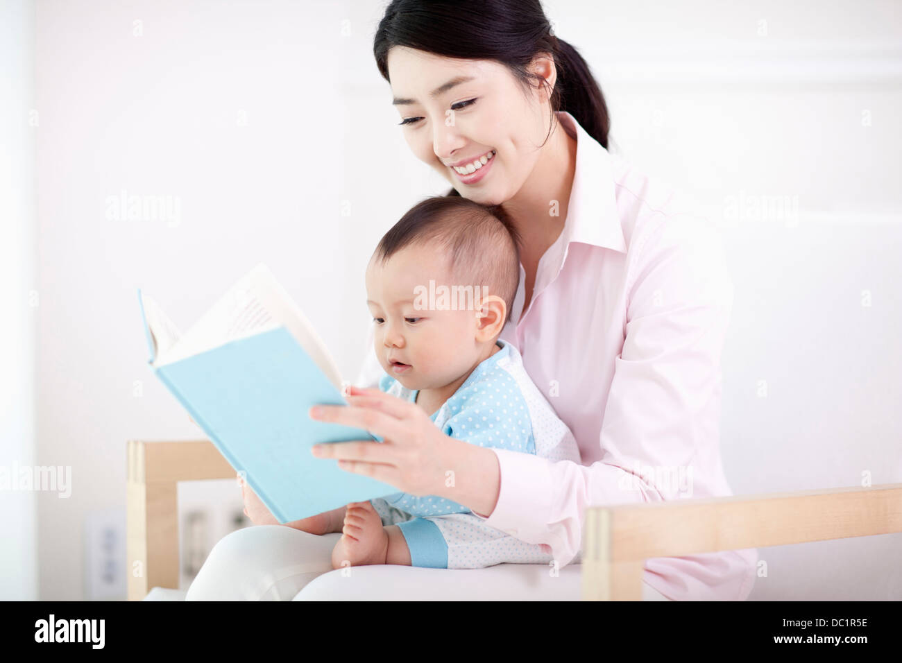 mother reading a book to baby Stock Photo - Alamy