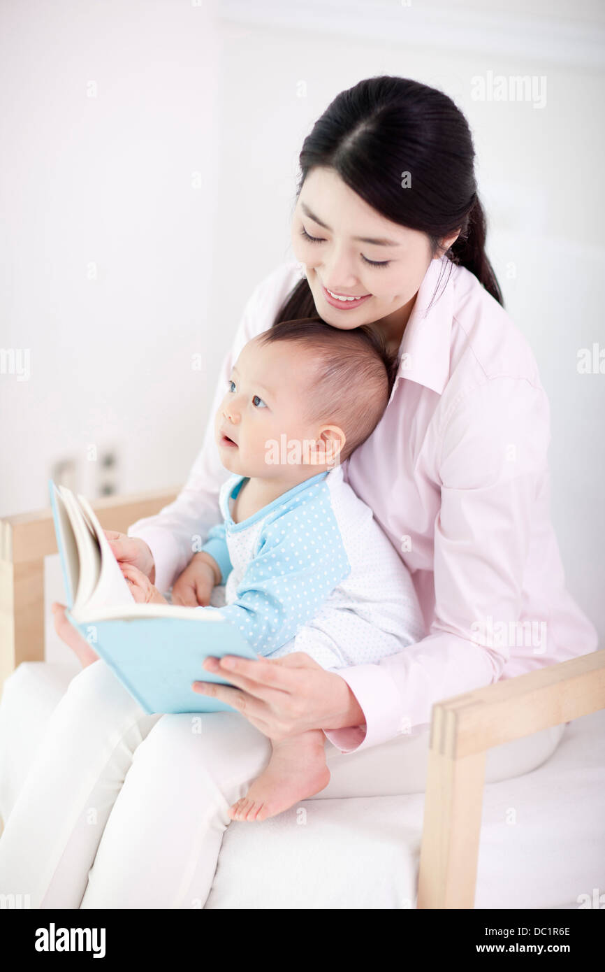 mother reading a book to baby Stock Photo - Alamy