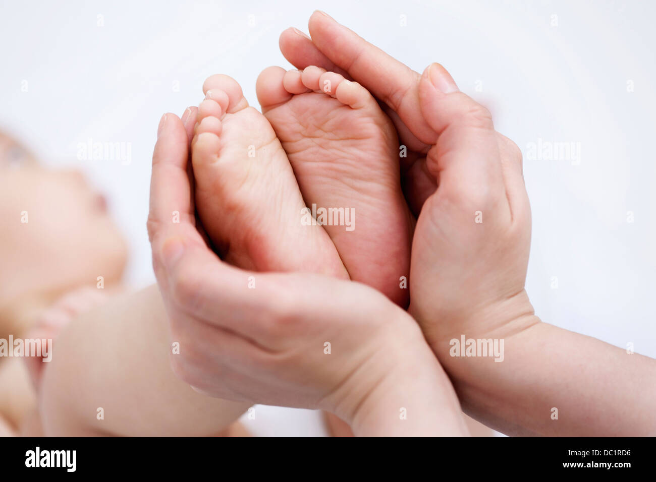 hand wrapping baby's feet Stock Photo - Alamy