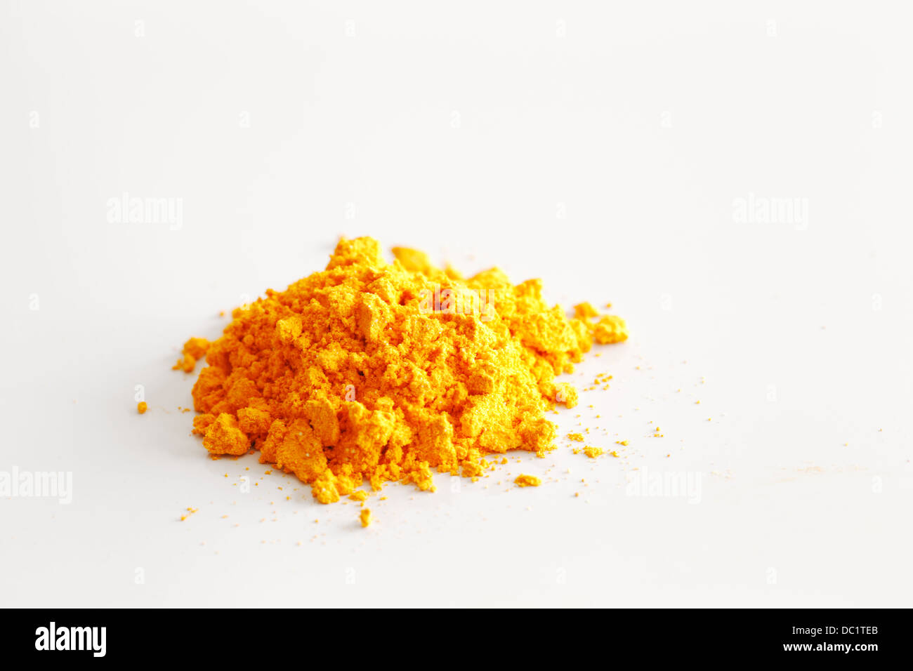 A macro image of the contents of a single turmeric capsule on white ...