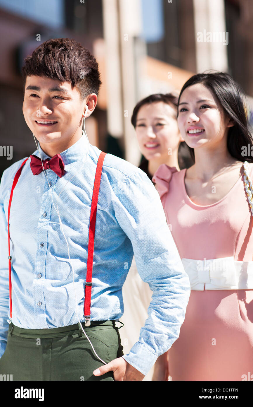 Stylish young Chinese people walking on street Stock Photo - Alamy