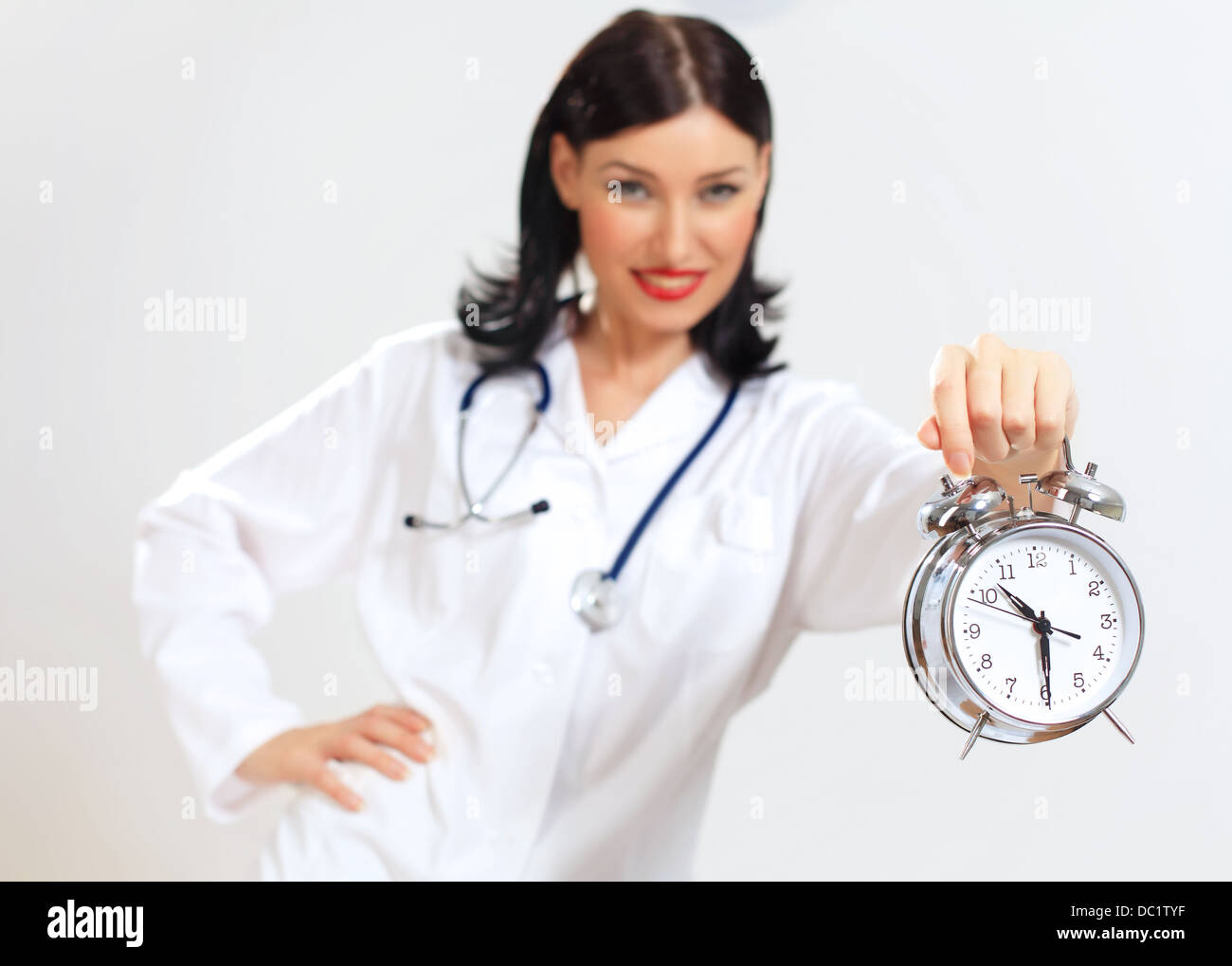 Young female doctor with clocks Stock Photo - Alamy