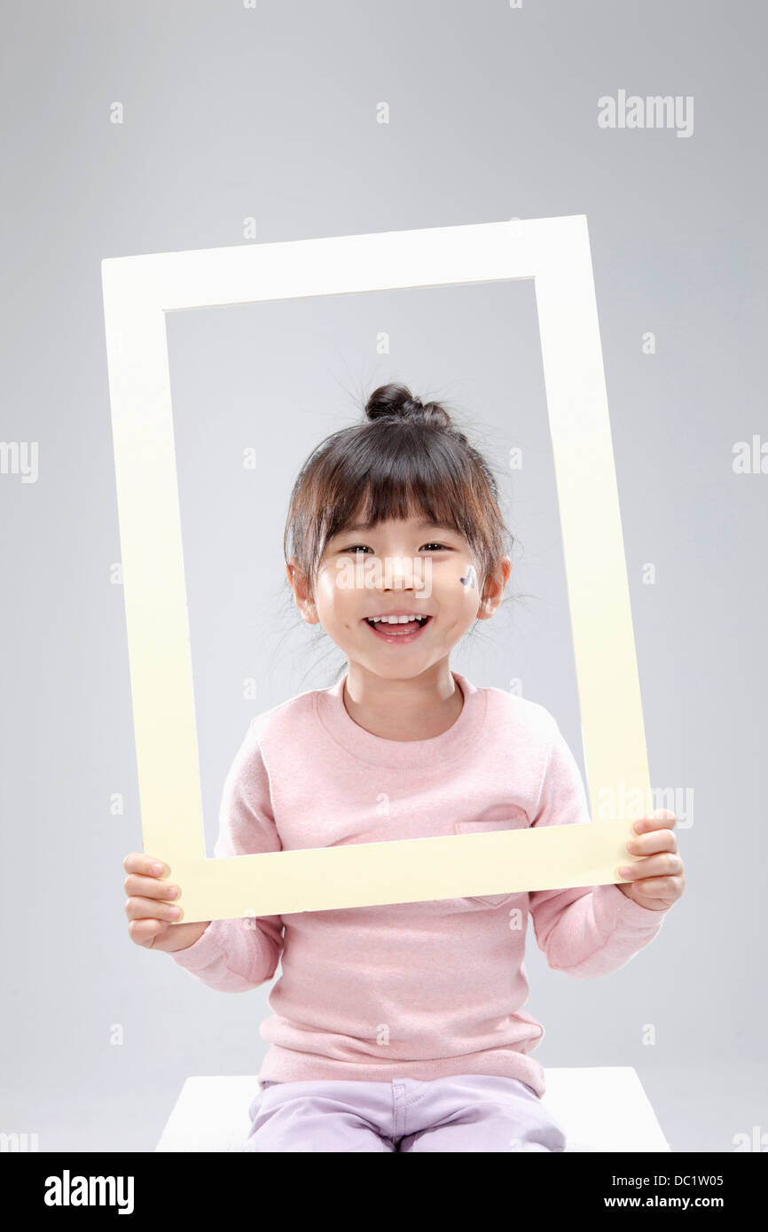 a girl inside an empty frame Stock Photo - Alamy