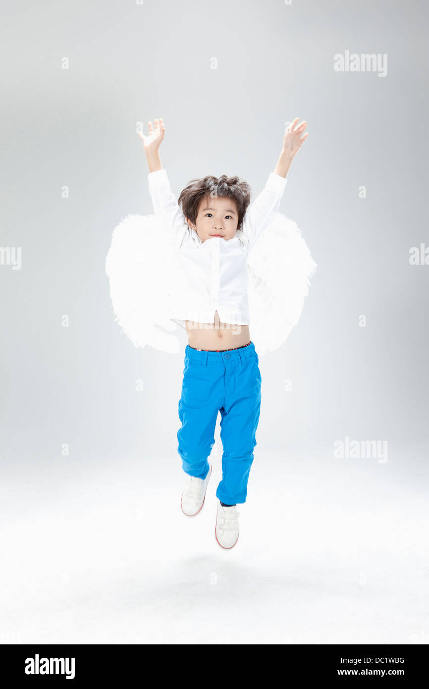 a boy with angel wings flying Stock Photo - Alamy