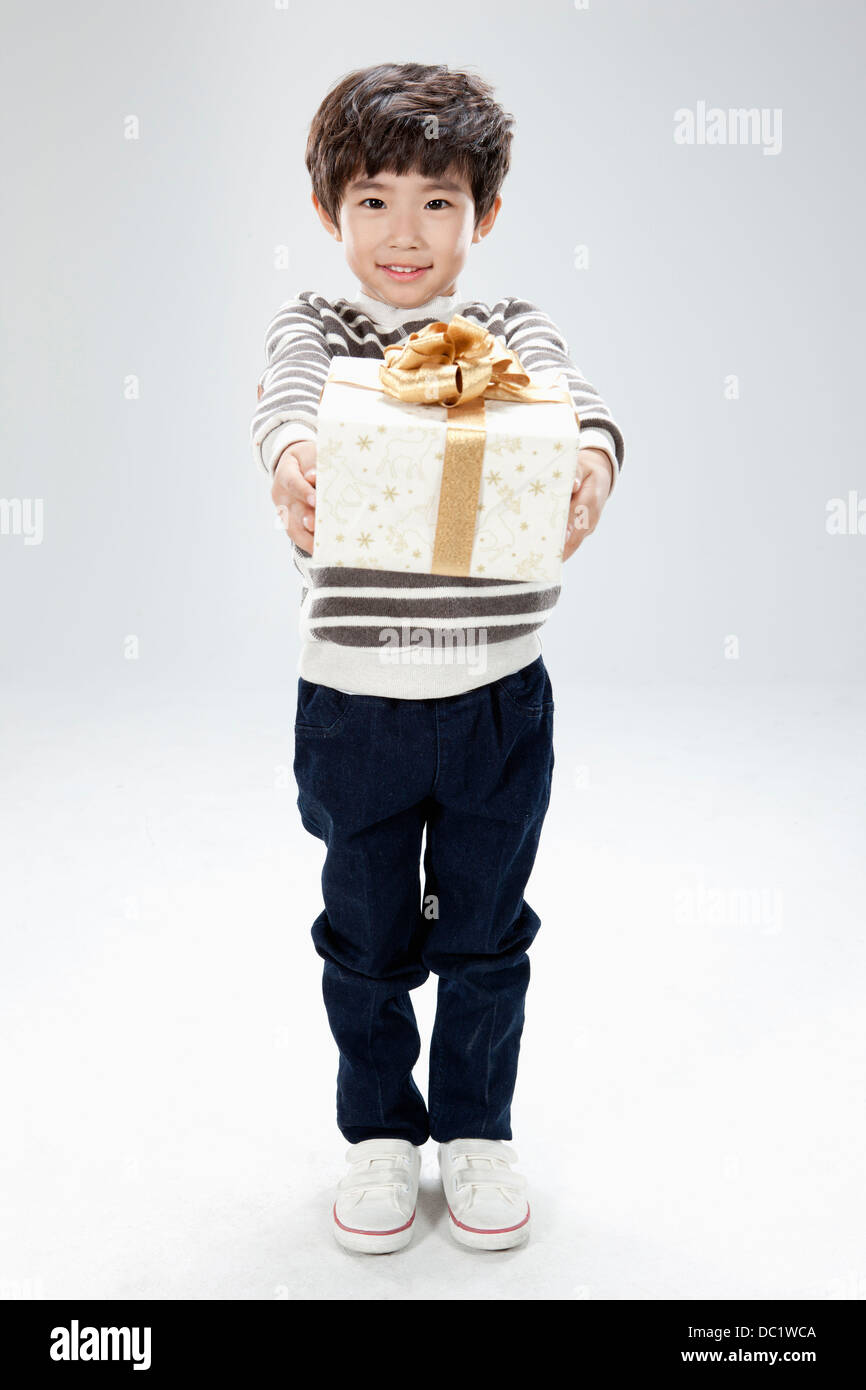 a boy holding a present Stock Photo - Alamy