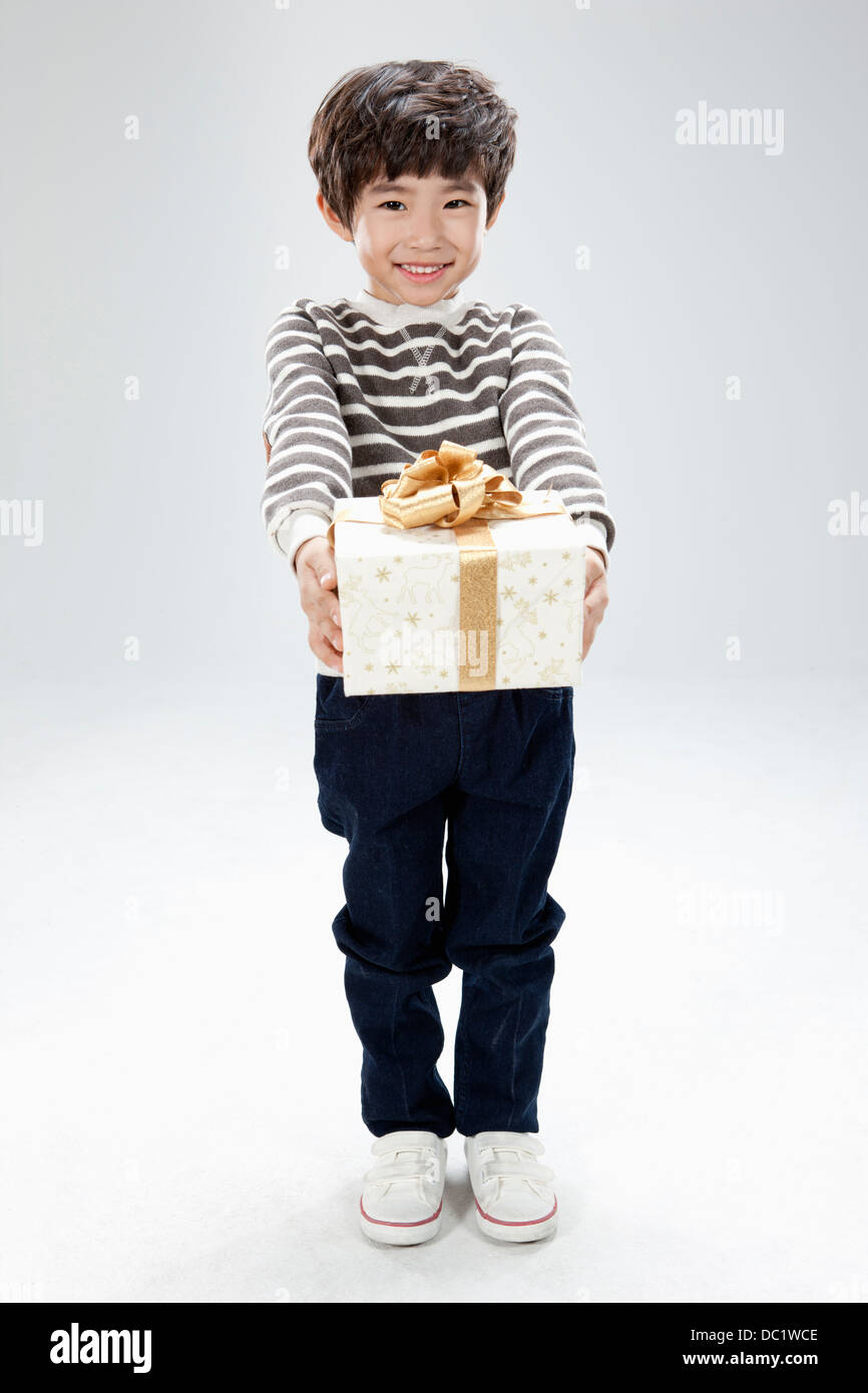a boy holding a present Stock Photo - Alamy