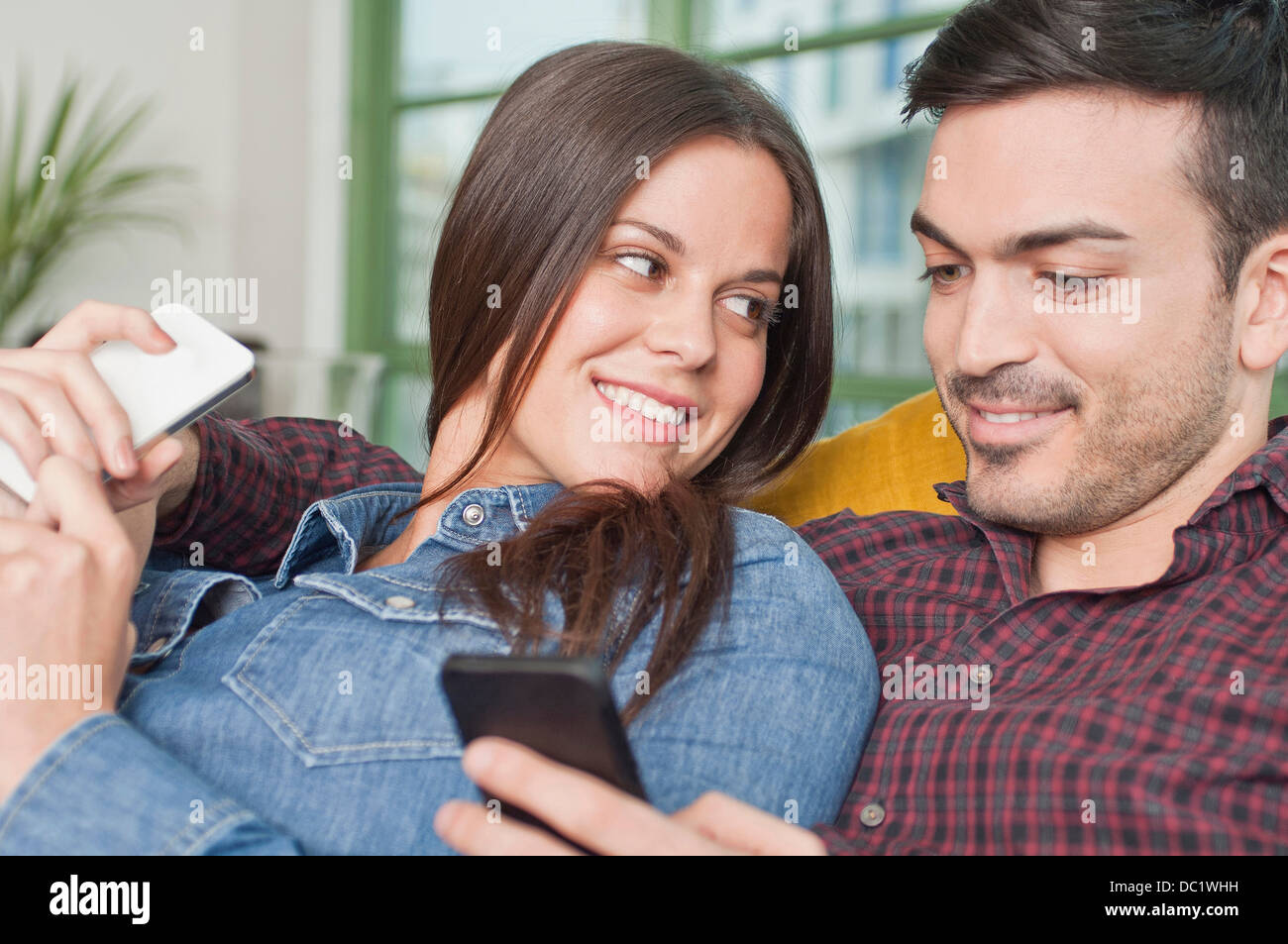 Young couple smiling using hi-res stock photography and images - Alamy