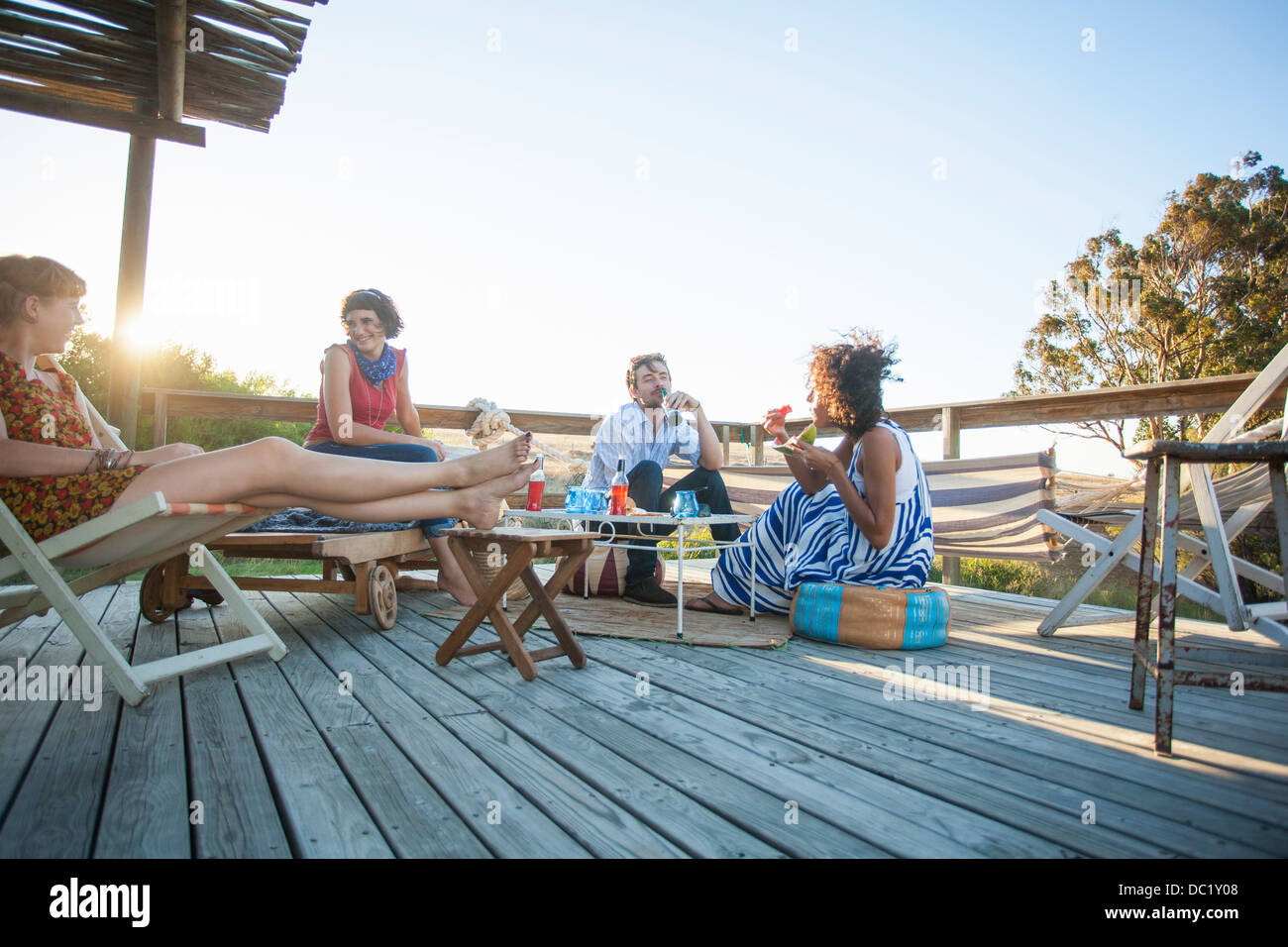 Young friends sitting together on balcony Stock Photo - Alamy