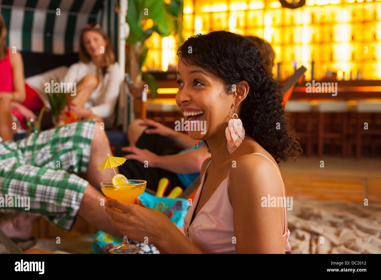 Friends enjoying cocktails in bar Stock Photo - Alamy