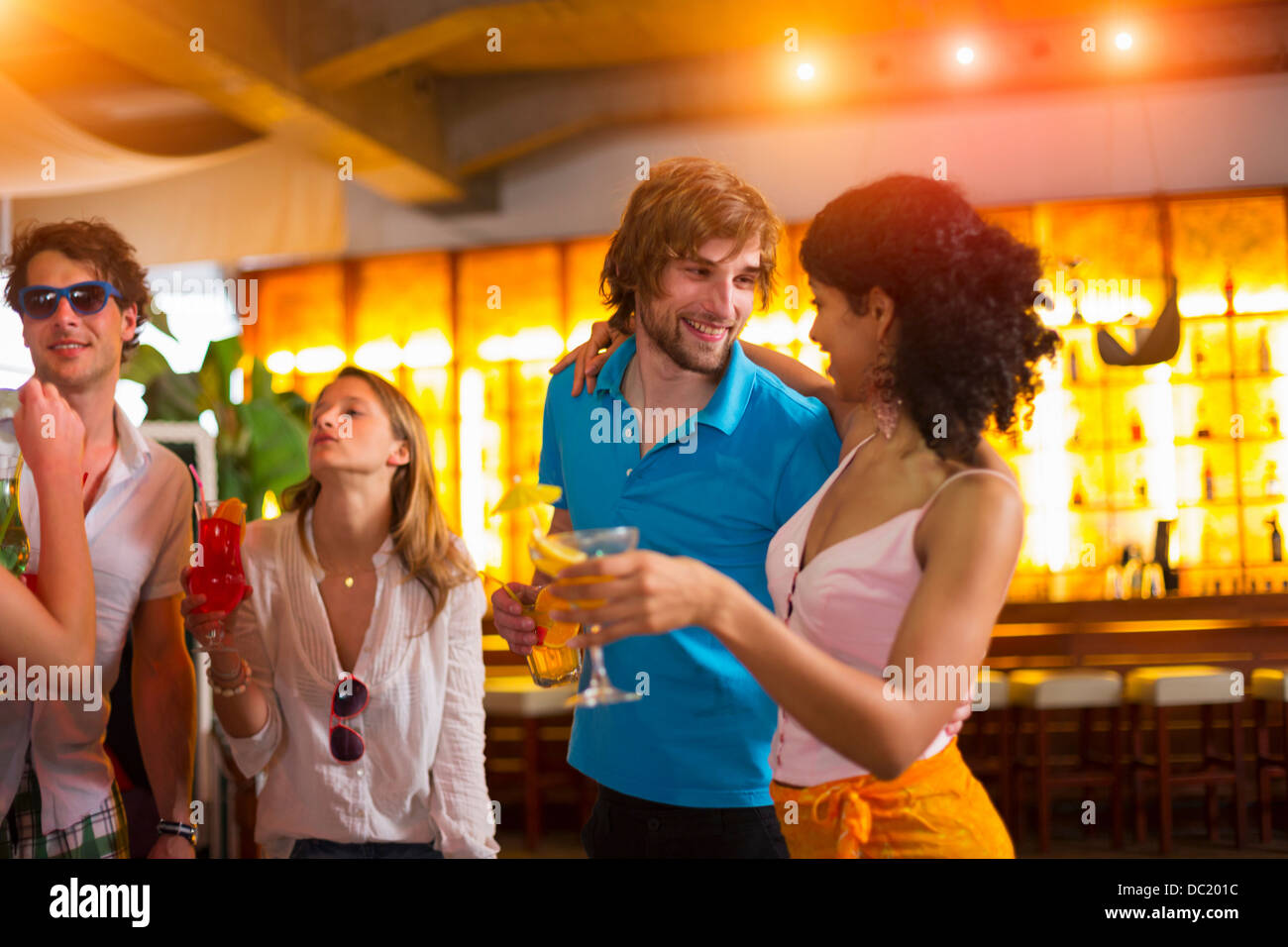 Group of friends with cocktails in bar Stock Photo - Alamy