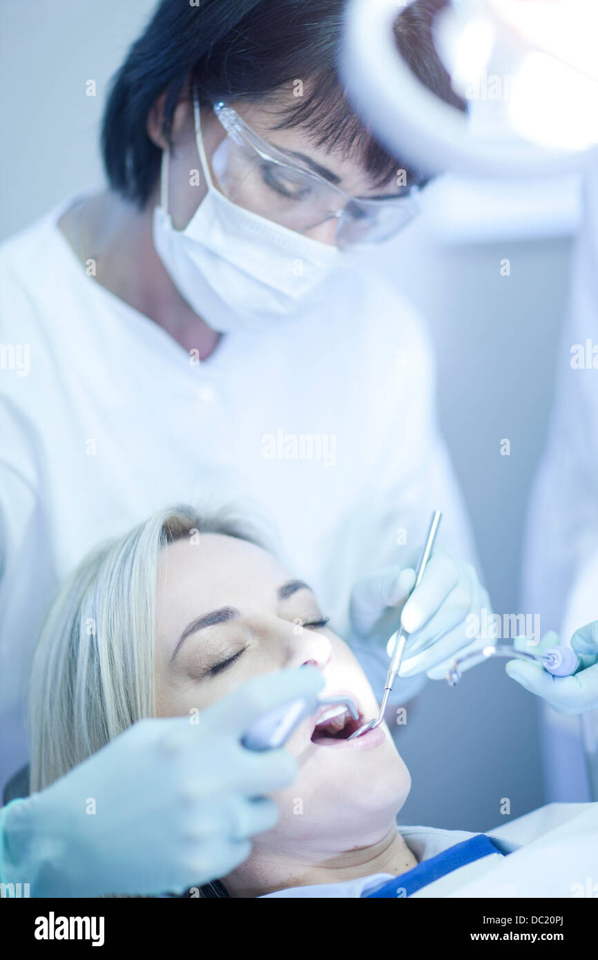 Woman dentist examining patients teeth hi-res stock photography and ...