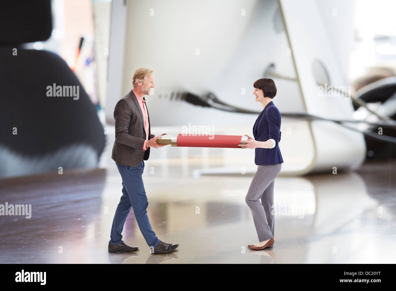Office colleagues carrying large USB stick on oversized desk Stock ...