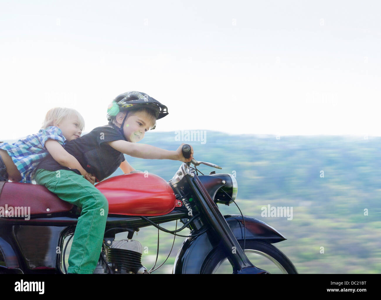 Brothers riding motorcycle Stock Photo - Alamy